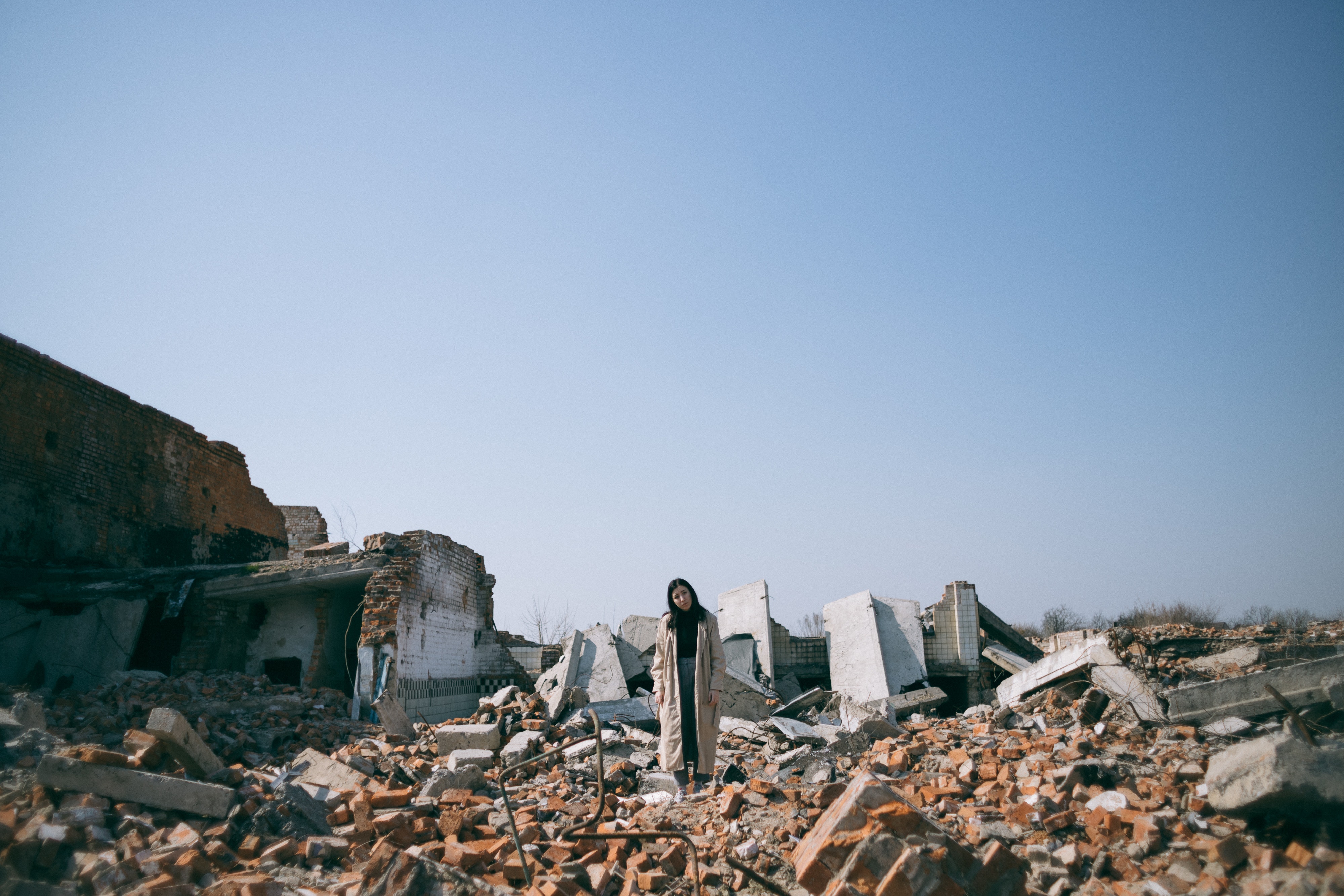woman-standing-on-ruins-of-a-building – International Journal of ...